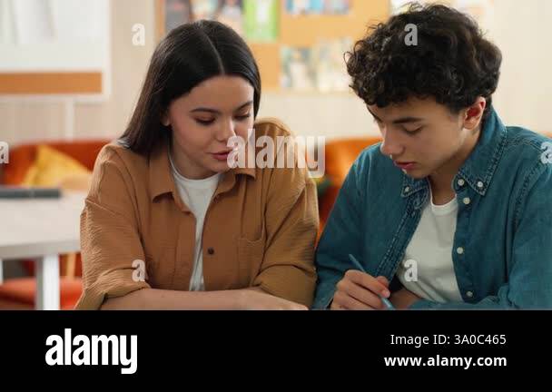 Two Caucasian students friends classmates solve difficult learning task ...