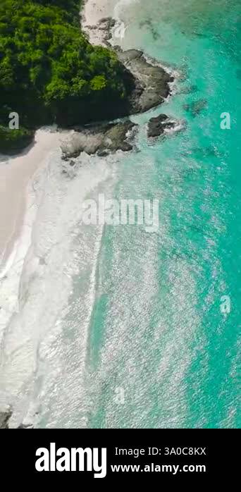 White beach and turquoise ocean waves and corals. El Nido, Palawan ...