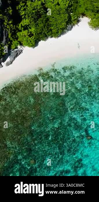 Serenity Beach with white sand and turquoise sea water and corals. El ...