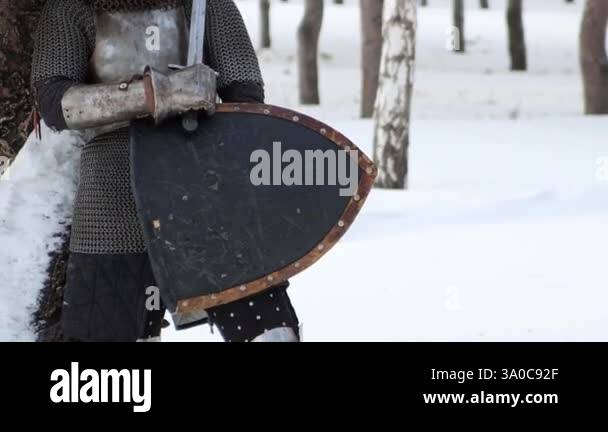 Portrait of a medieval knight in full armor wearing a helmet with a ...