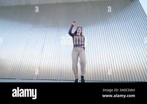 Talented dancer showcases energetic moves against a modern metallic ...