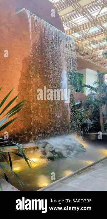 water flowing into the decorative pool from an artificial waterfall ...
