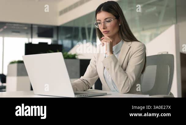 Thoughtful serious Hispanic company CEO woman in glasses working at ...