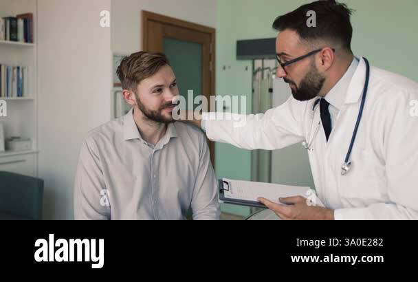 Positive doctor man telling good optimistic news to male patient ...