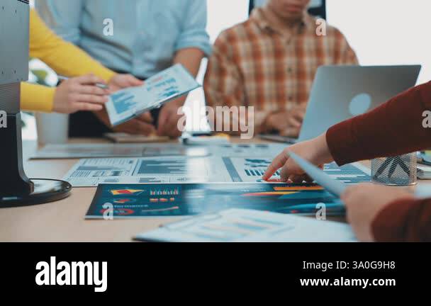 A group of diverse business professionals engaged in collaboration and ...