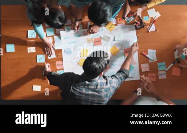 Top view of project manager writing and sticking stick notes. Aerial ...