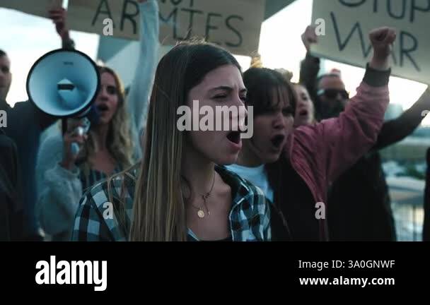 Young blonde woman with group diverse people protesting angry shouting ...