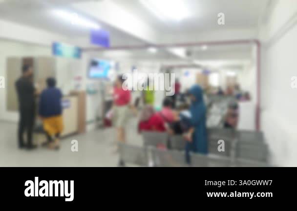 An intentionally blurred image showing a diverse crowd in a waiting ...