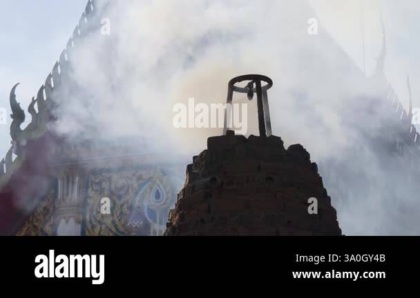 Smoke billows from fireworks oven at ancient Thai temple to ward off ...