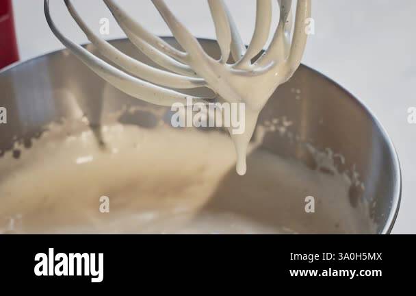 Food preparation. Beaten mass of eggs and sugar in a kitchen mixer ...