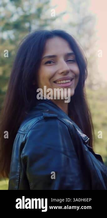 Vertical. A woman with a warm smile, bathed in the golden light of a ...