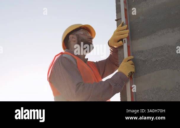 Slow motion of construction workers measuring a building under the sun ...