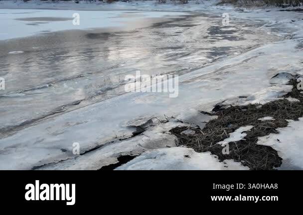 Winter landscape with ice on the river. Cracked ice on the lake. Frosty ...