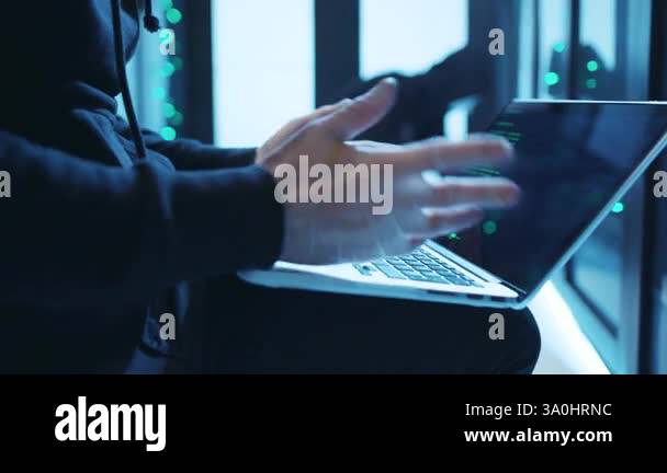 A highly focused individual is intently typing complex code on a sleek ...