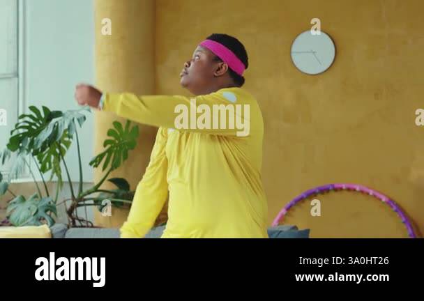 A man in a yellow shirt and pink headband shares his fitness journey ...