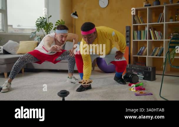 This video features two men and a woman working out in a cozy living ...