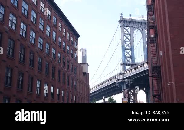 New York City Manhattan Bridge in Dumbo, Brooklyn. Red brick building on Washington street near ...
