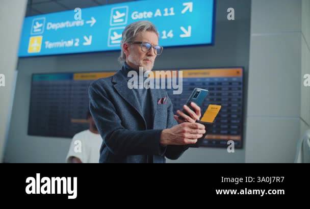 Airport Terminal: Mature Man Scanning Plane Ticket Using Smartphone to ...
