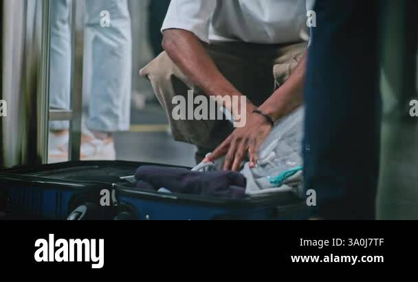 Airport Security Checkpoint: African American Man Removes Liquids from ...