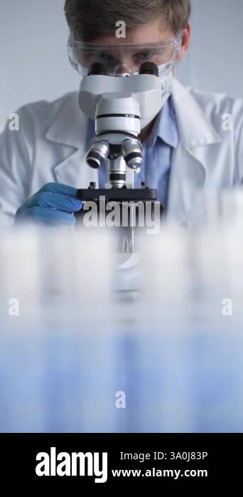 Man scientist researcher wearing blue gloves, protective glasses and ...