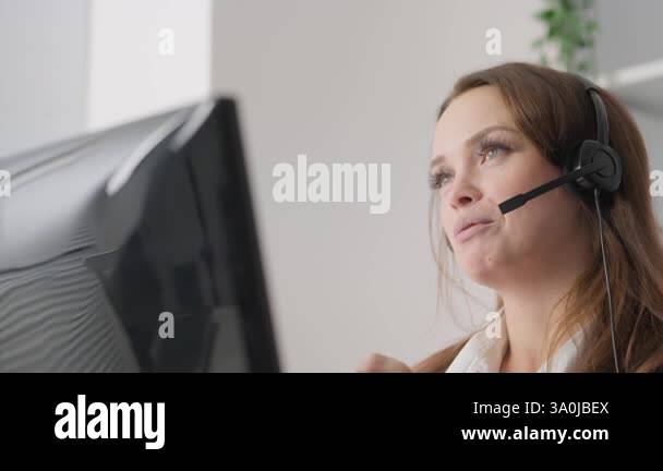 In a modern office, a customer service representative, with a headset ...