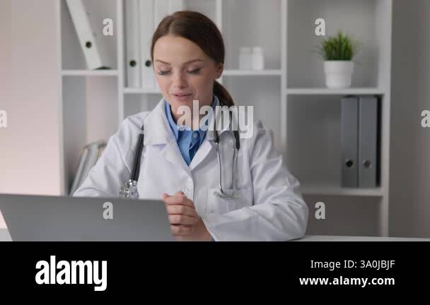 A dedicated female doctor in a white coat is conducting a virtual ...