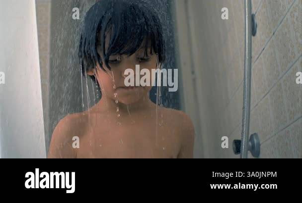 Young child stands under shower, captured in ultra slow-motion at 800 ...