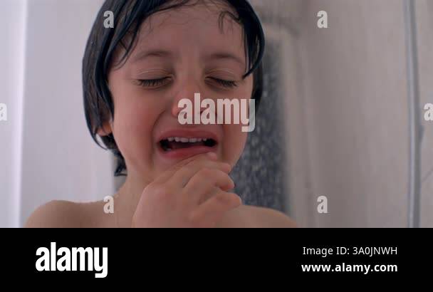 Young child crying under shower, captured in ultra slow-motion at 800 ...