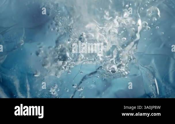 Super Slow Motion Shot of Ice and Air Bubbles in Crystal Clear Water at ...