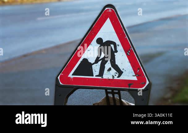 Roadwork caution sign in United Kingdom. Traffic advisory board ...