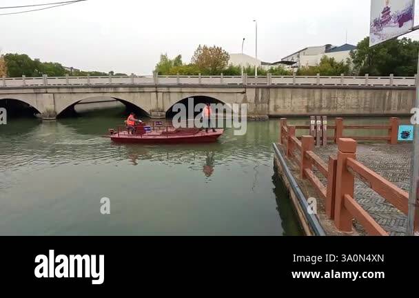 Shanghai, China, December 7, 2024: Workers cleaning the river with a ...