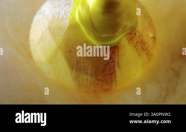 Ink spill. Acryl leak. Yellow gel emulsion drop dissolving on ...