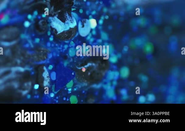 Vertical video. Acrylic paint mix. Wet glitter spill. Defocused blue ...
