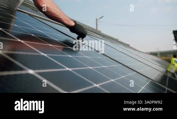 Close up of electrician installing solar panel system outdoors ...