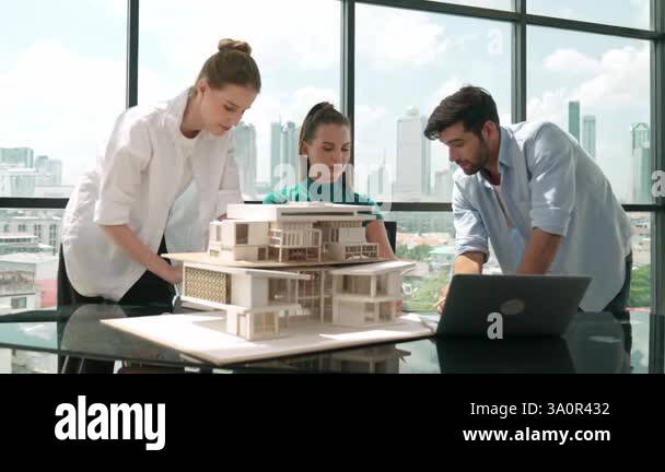 Architect engineer team working together to analyze house model ...