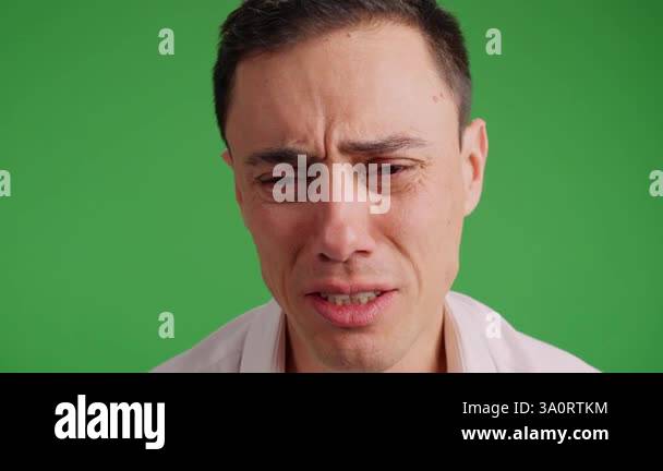 Close up of a very sad man crying, who finally looks at the camera ...