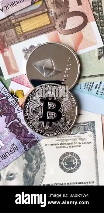 Round metal bitcoin on a background of paper banknotes of different ...
