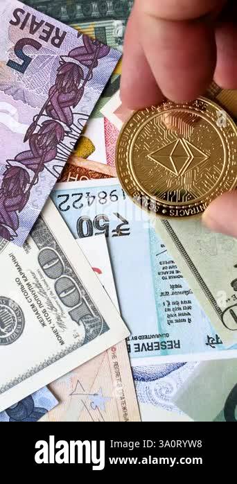 Round metal bitcoin on a background of paper banknotes of different ...