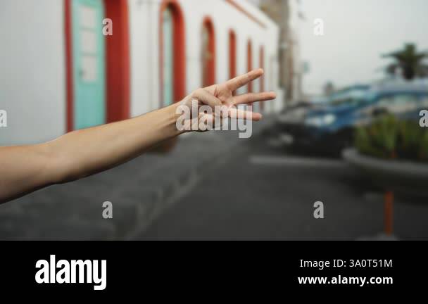 Man's hand making a thumbs-up gesture and counting with fingers on a ...
