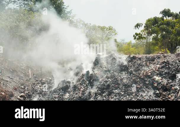 Garbage, fire burning and smoke in landfill. Also called trash, waste ...