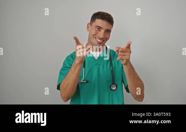 Handsome man making ok gesture wearing scrubs and stethoscope smiling ...