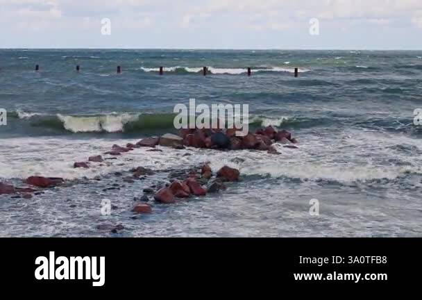 Choppy baltic sea under overcast sky with dark waves breaking upon ...