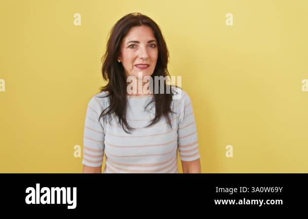 Joyful mature hispanic woman celebrating victory with arms raised ...