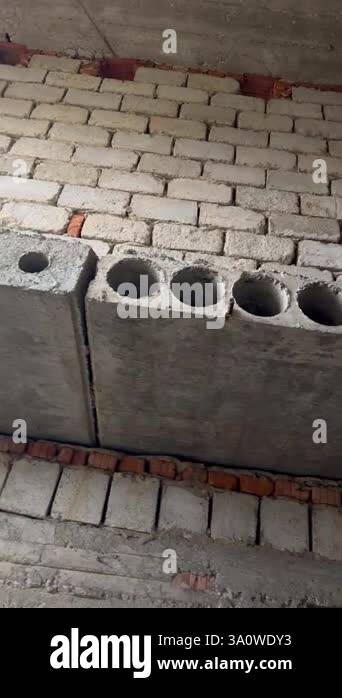 an unfinished building inside where hollow core slabs, white and red ...