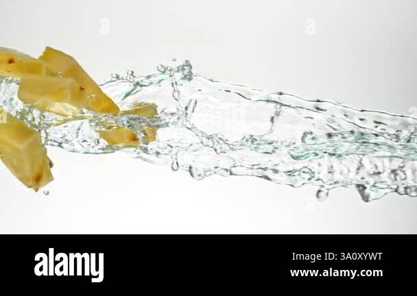Super Slow Motion of Flying Pineapple Slices in Water Splashes, White ...