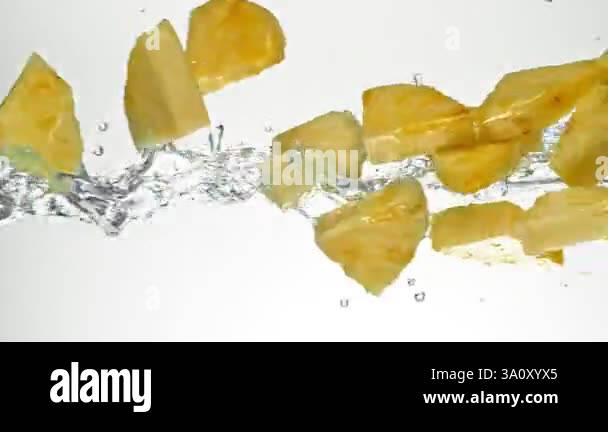 Super Slow Motion of Flying Pineapple Slices in Water Splashes, White ...