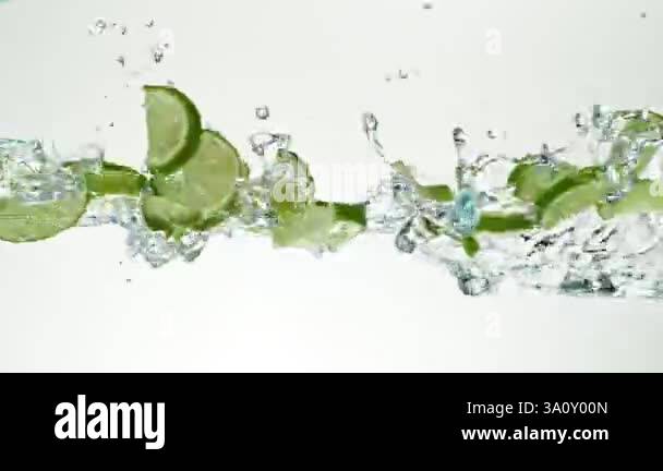 Super Slow Motion of Flying Lime Slices in Water Splashes, White ...