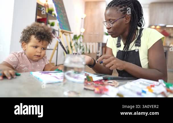 In a cozy, well-lit room, a mother and her child immerse themselves in ...