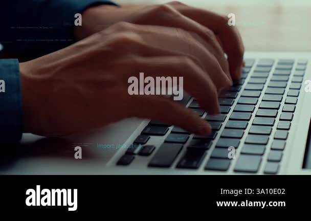 Computer programmer uses capable laptop computer to develop programming code of new software ...