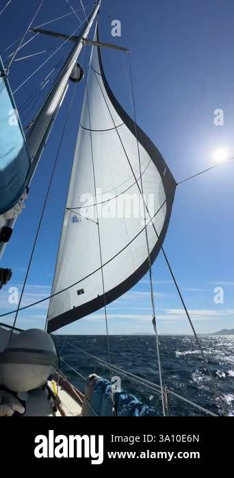 Video footage of a sailboat sailing along in the wind with fore-sail up ...